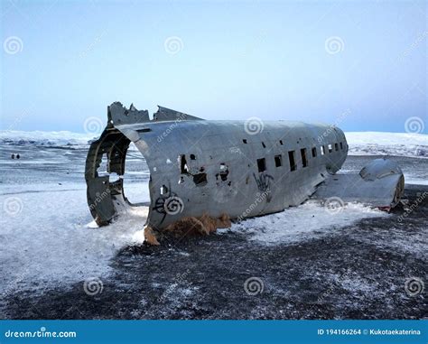 The Wreckage Of An Abandoned Dc 3 Plane On A Black Ocean Beach In