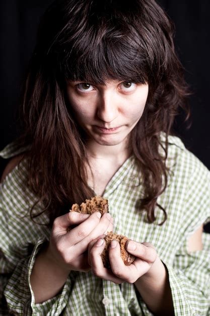 Premium Photo Portrait Of A Poor Beggar Woman With A Piece Of Bread