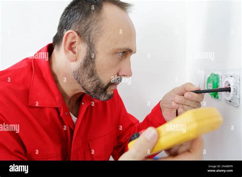 Electrician Testing Plug Socket With Multimeter Stock Photo Alamy