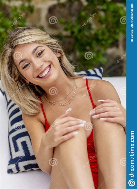 A Lovely Blonde Bikini Model Enjoys The Summer By The Pool Stock Image Image Of Bikini