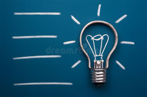 Light Bulb Symbol Representing Bright Idea In Front Of Blue Board