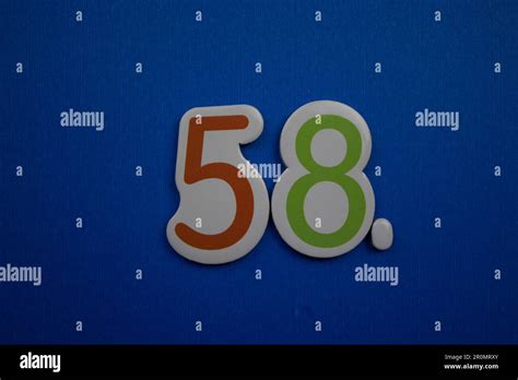 The Number 58 Placed On A Blue Background Photographed From Above Colored Red And Green Stock