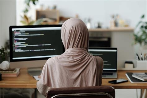 Premium Photo Rear View Of Muslim Female Programmer In Hijab Sitting In Front Of Computer Screen