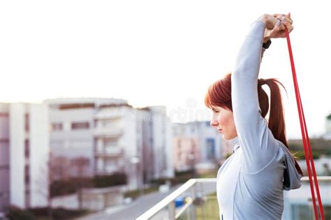 Woman S Home Workout Routine With Resistance Band At Balcony Redhead