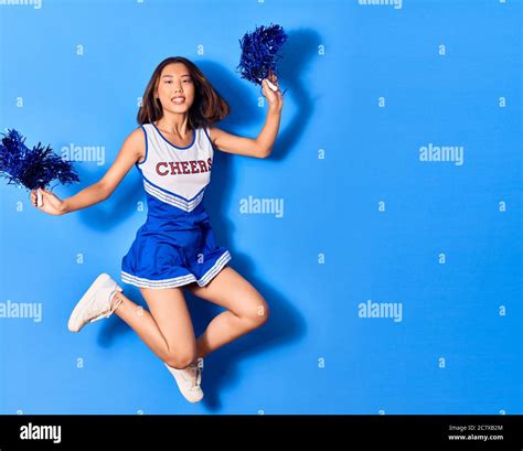 Young Beautiful Chinese Girl Smiling Happy Wearing Cheerleader Uniform