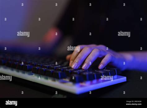 female cyber hacker gamer using keyboard and mouse to playing games or