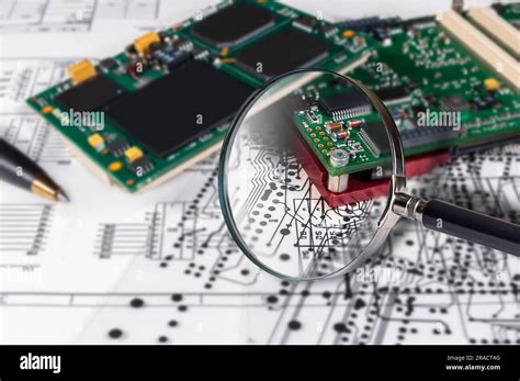 Electronic Modules Magnifying Glass And Pen On Background Of Schematic