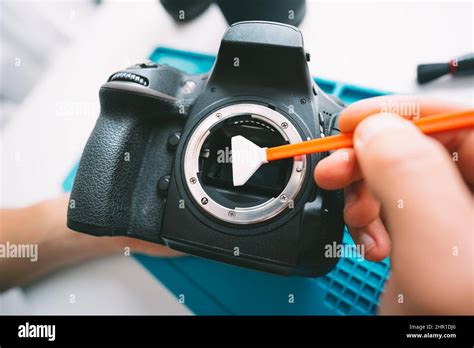 Man Cleaning Camera Sensor With Camera Sensor Cleaner Or Cleaning Swab