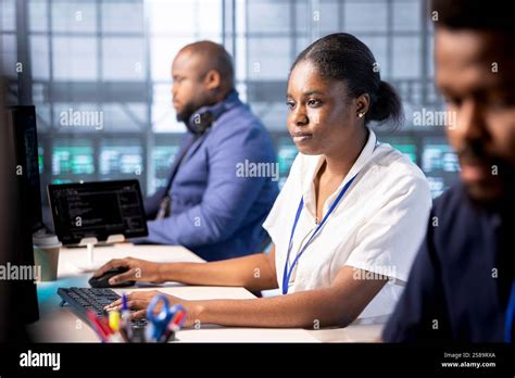 African American Developer In Data Center Workspace Using Diagnostic Tools And System Monitoring