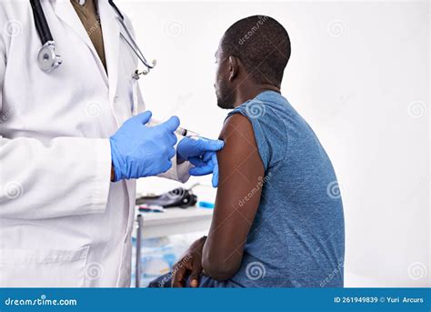 Hes In For His Annual Flu Shot A Male Doctor Giving His Patient An