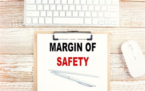 Premium Photo MARGIN OF SAFETY Text On Clipboard With Keyboard