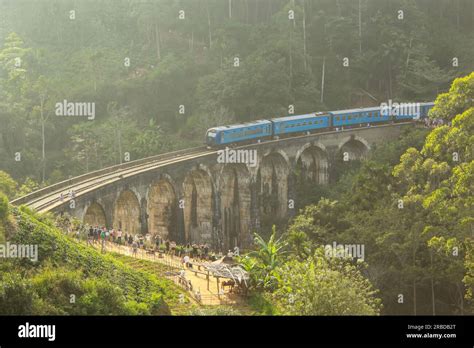 Spectacular View Of A Blue Train Crossing Over Nine Arches Bridge In