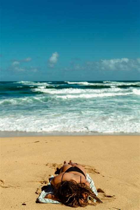 Woman Sunbathing On Beach Photo Free Beach Image On Unsplash