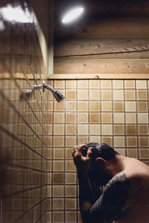 A Handsome Tattoo D Man Washes His Face In The Shower Del Colaborador De Stocksy Rachel