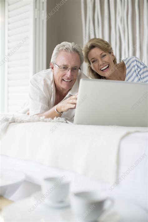 Older Couple Using Laptop On Bed Stock Image F014 1944 Science