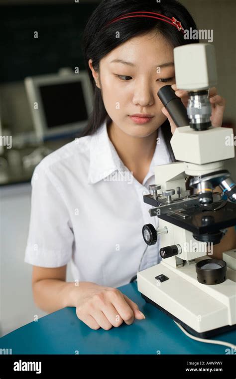 Female Babe Using A Microscope Stock Photo Alamy