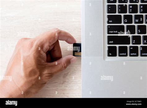 Hand Inserting Memory Card Into Laptop Slot Stock Photo Alamy