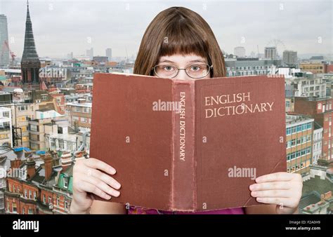 Girl With Spectacles Looks Over English Dictionary Book And London