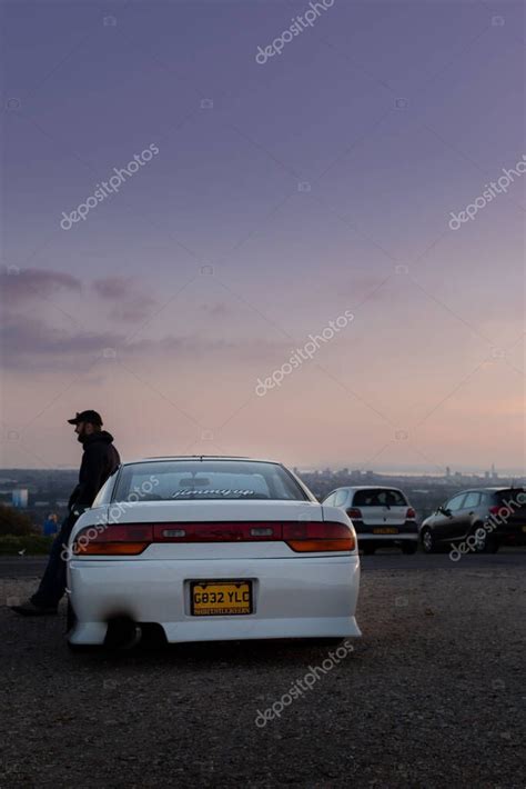 The Nissan S13 240sx From The Back And Its Owner Sitting Against It