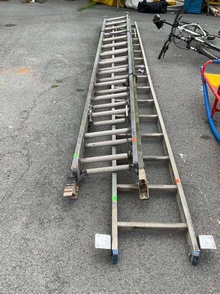 Ladders Lot One 16ft Aluminum Section Plus A 28ft Fiberglass
