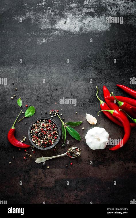 Red Hot Chili Pepeprs And Peppercorns On Black Metal Background Top