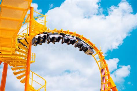 Yellow Roller Coaster Roll Loop Curve High To Blue Sky Summer Season Activity Funny At Amusement