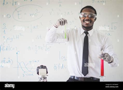 African Science Teacher Conducting Experiment Mixing Liquids In Flask
