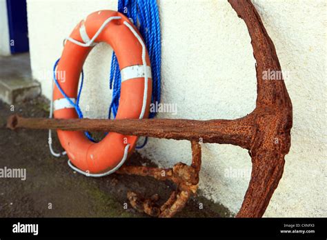 Rusty Anchors And Lifbuoy Outside Harbour Masters Office In The Scottish Ayrshire Town Of Girvan