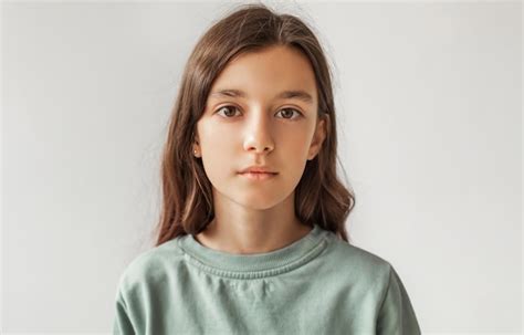 Portrait Of Serious Preteen Girl Looking At Camera Gray Background