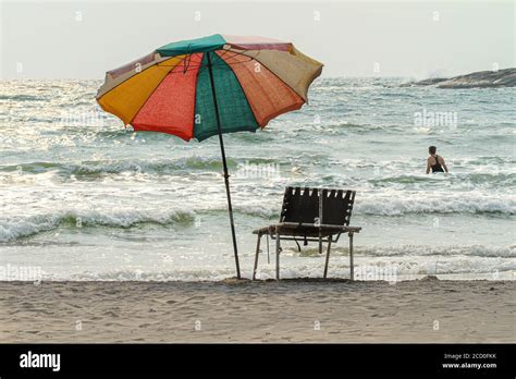Tourist Enjoying Seashore And Surfing Activities On Holidays In Kovalam