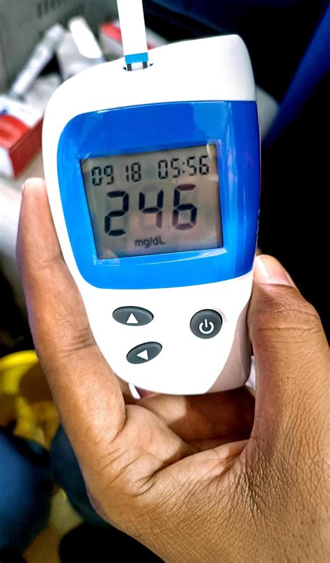 A Close Up Of Blood Glucose Meter With High Sugar Reading On Wooden