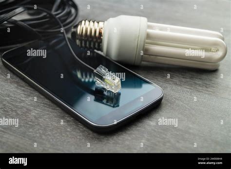 Energy Saving Lamp Smart Phone And Network Plug Symbolic Image For