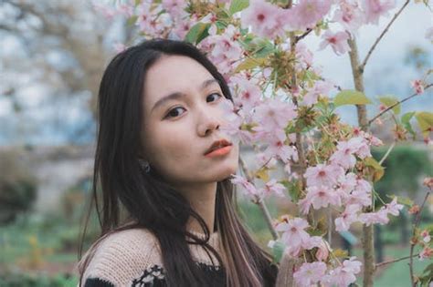 걷고 있는 과수원 꽃 꽃이 만개한 나무 농촌의 뒷모습 봄 수직 쐈어 여성 초원 패션 사진 평상복에 관한 무료 스톡 사진