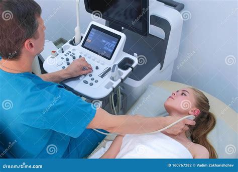 Man Doctor Examining Patient`s Woman Thyroid Gland Using Ultrasound