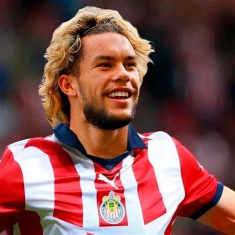 Download Smiling Soccer Playerin Striped Uniform Wallpaper