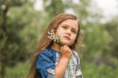 Premium Photo Girl With Lily Of The Valley In Nature
