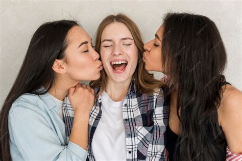 Free Photo Ladies Kissing Girlfriend On Cheeks Posing For Camera