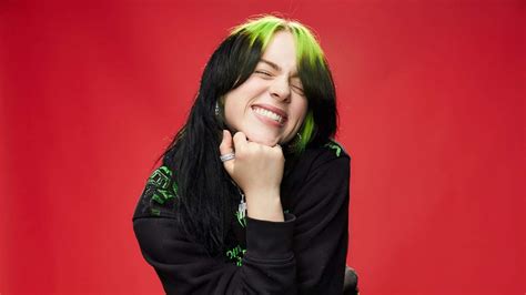 Download Singer Billie Eilish Working On Her Laptop Wallpaper