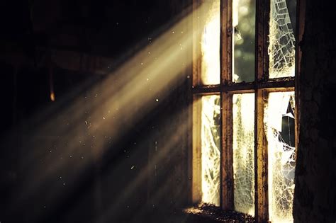 A Sunbeam Piercing Through A Shattered Window Casting Dramatic Light