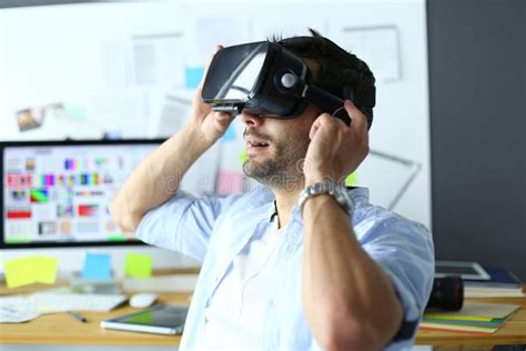 Young Male Software Programmer Testing A New App With 3d Virtual Reality Glasses In Office