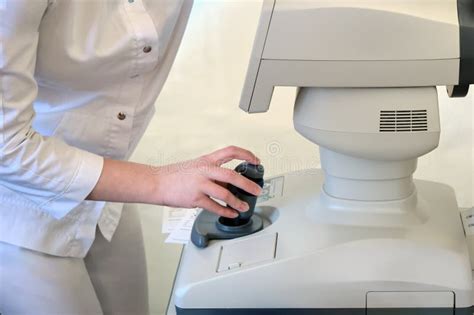 A Female Ophthalmologist Doctor Takes Measurements Of Visual Acuity On