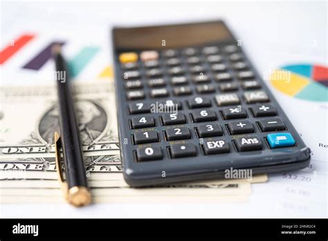 Pen And Calculator On Chart Or Graph Paper Financial Account