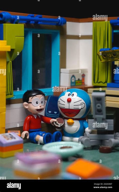 Japanese Toy Figures Nobita And Doraemon Sitting And Eating Chocolate