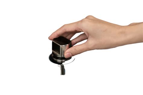 In The Kitchen A Womans Hand Rotates The Knob On A Gas Stove