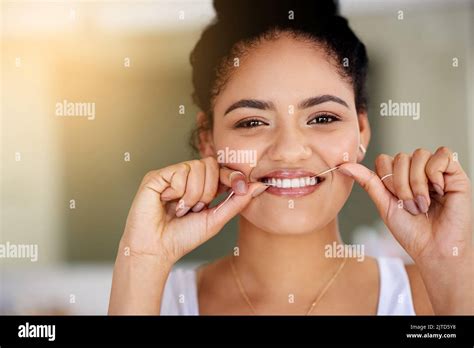 Flossing For The Love Of Her Teeth Portrait Of An Attractive And Happy