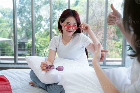 The Lgbt Couple Trying On Fashion Glasses Together As They Arrive In