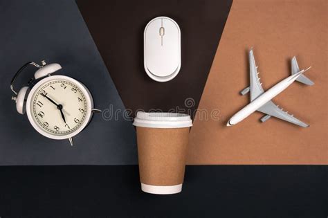 Alarm Clock Computer Mouse Cup And Airplane On A Paper Background