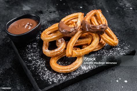 초콜릿 소이스와 전통적인 멕시코 디저트 츄로스 검은 색 배경 위쪽 보기 가루로 빻은에 대한 스톡 사진 및 기타 이미지 가루로