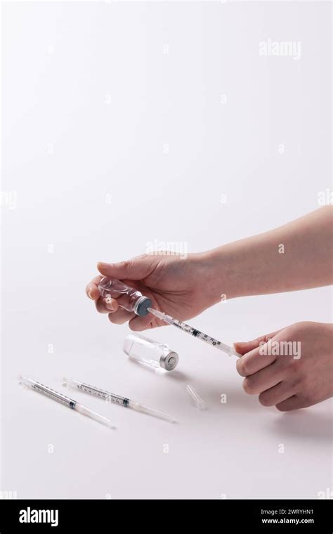 Putting A Syringe In An Injection Bottle Stock Photo Alamy
