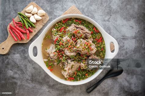 얇게 썬 초록색과 붉은색 고추를 얹고 라임 마늘로 간을 한 매운 돼지고기 등뼈 스튜는 새콤하고 매콤하지만 맛있는 맛이 있습니다 수프에 대한 스톡 사진 및 기타 이미지
